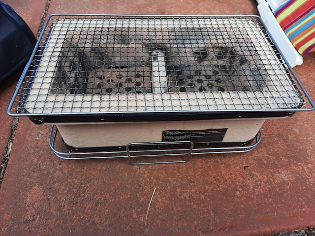 small hibachi grill heavy brick stone construction has holder and gril ...